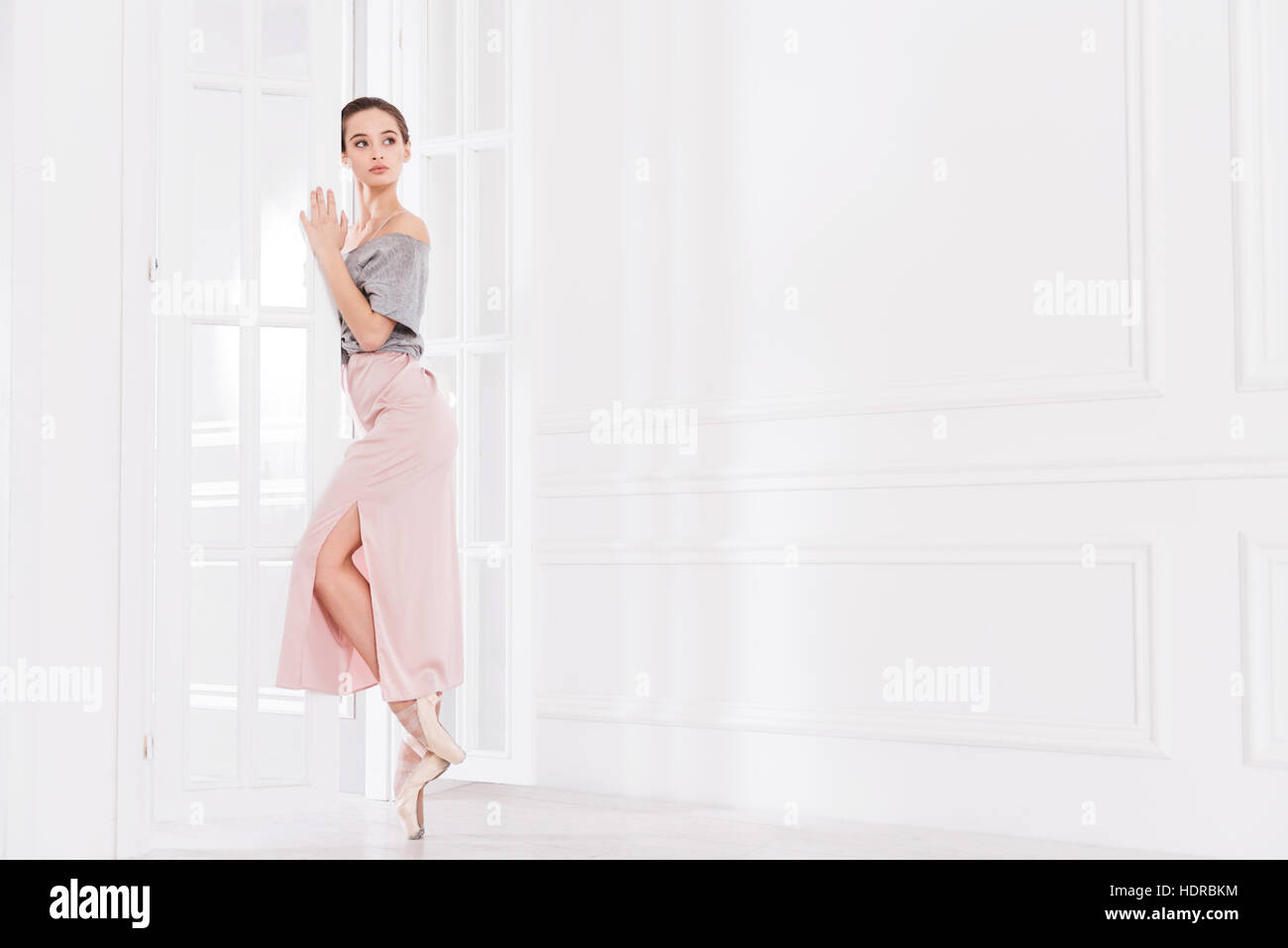 Graceful girl standing in the doorway Stock Photo - Alamy