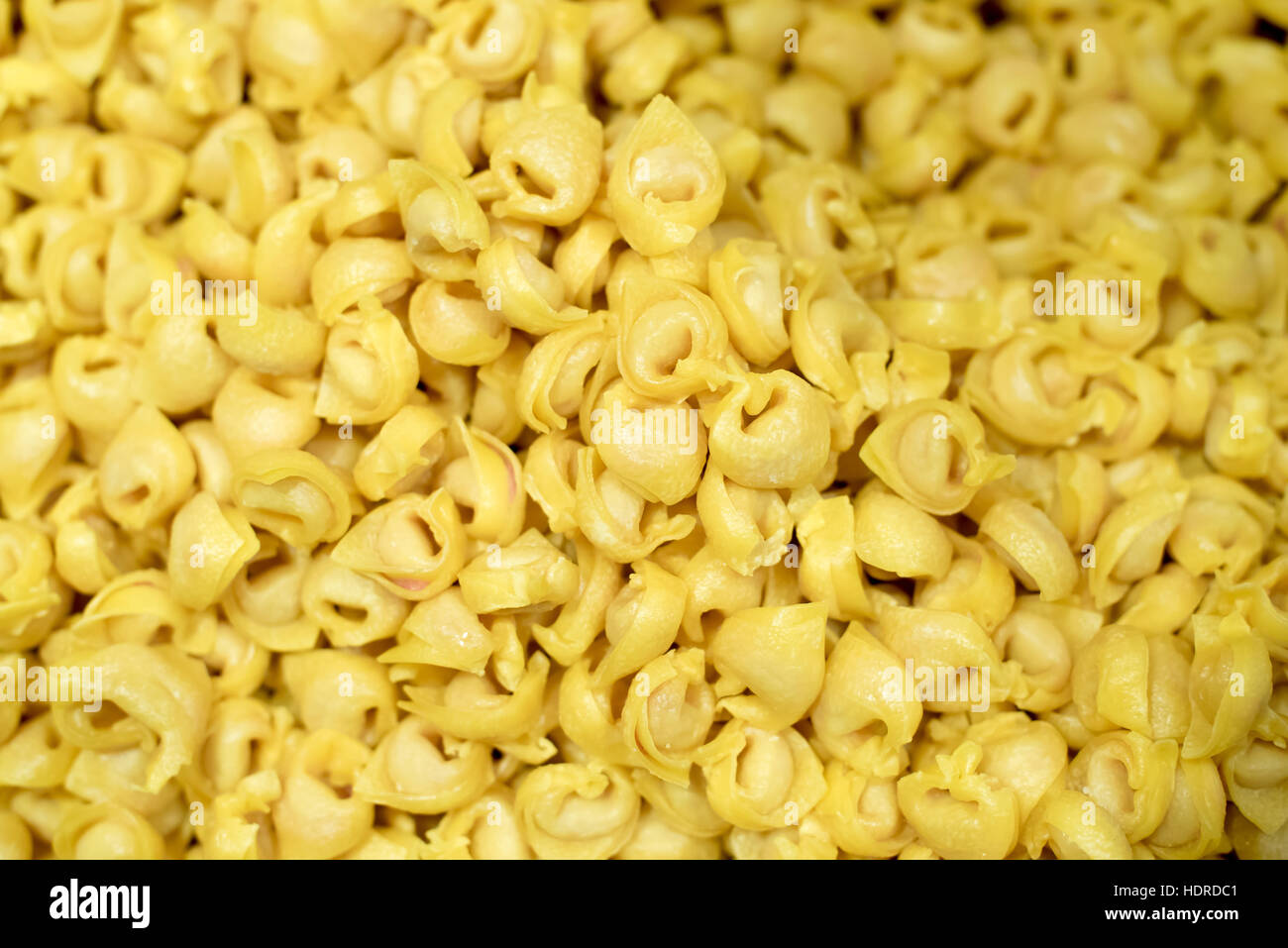 Pattern of yellow italian tortellini pasta Stock Photo - Alamy