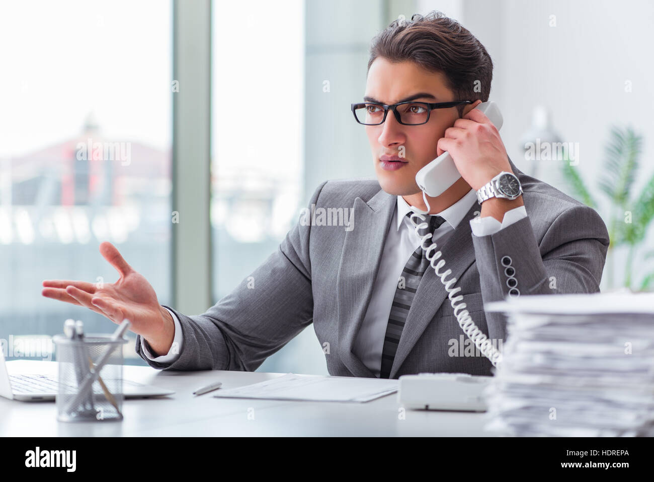 Angry helpdesk operator in the office Stock Photo - Alamy