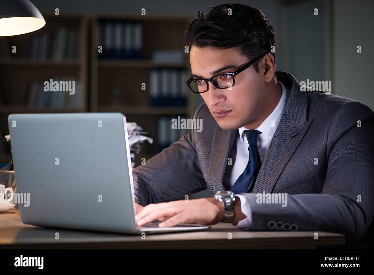 Man staying in the office for long hours Stock Photo - Alamy
