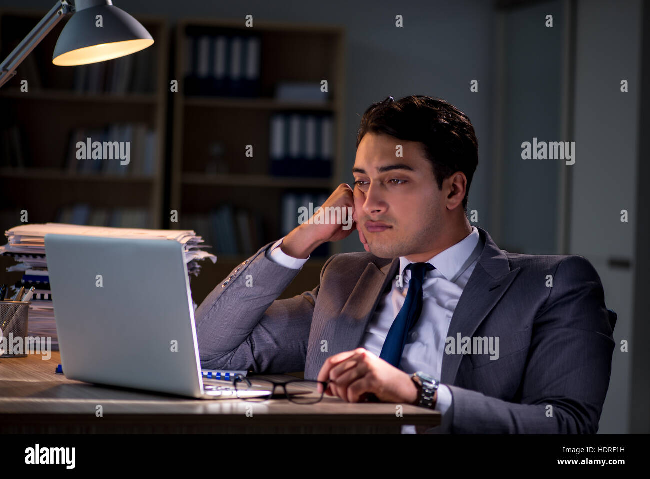 Man staying in the office for long hours Stock Photo - Alamy