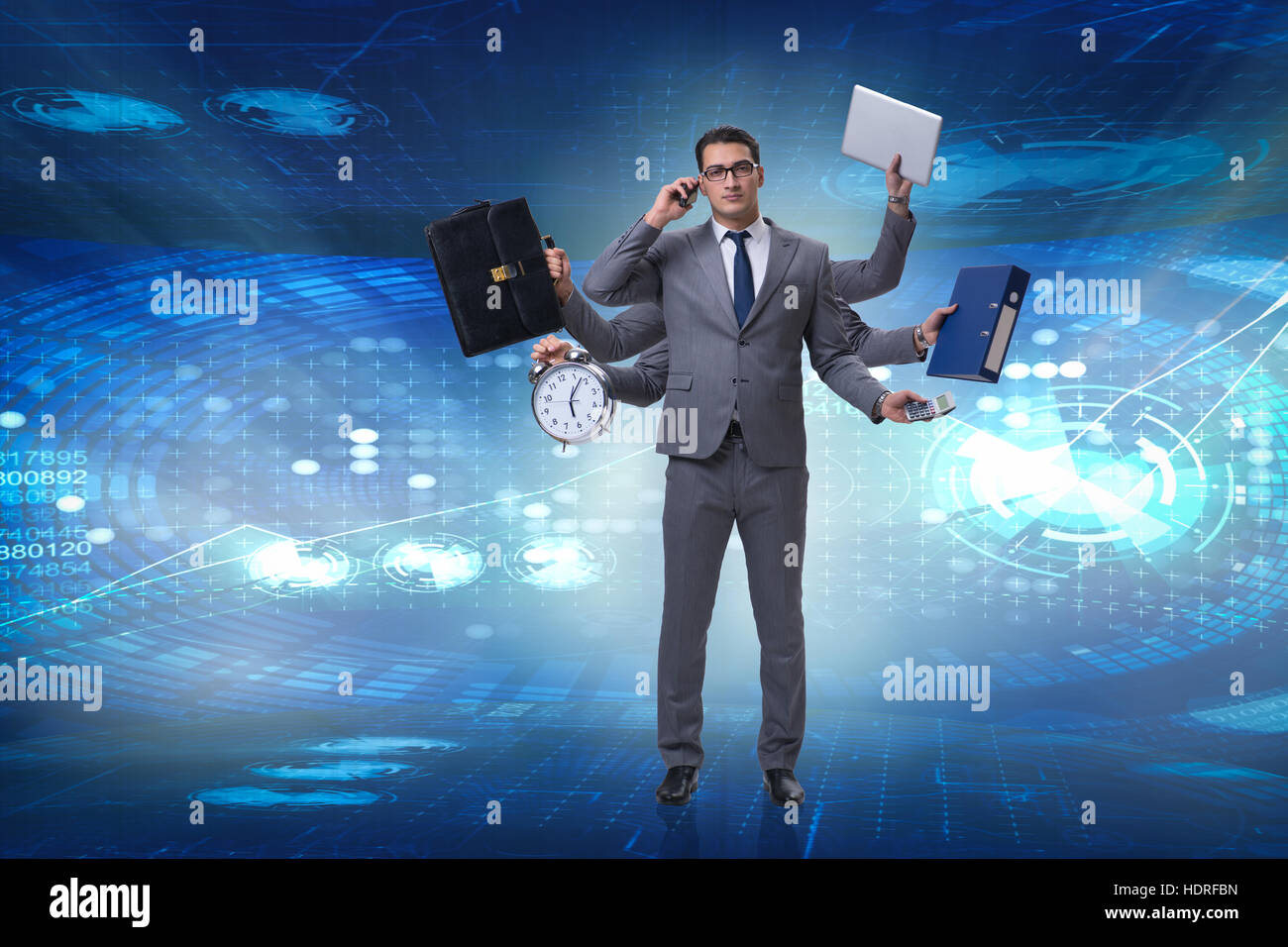 Young businessman in multitasking concept Stock Photo - Alamy