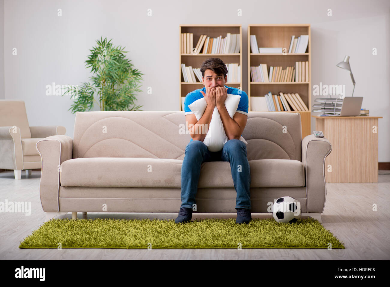 Man watching football at home Stock Photo - Alamy