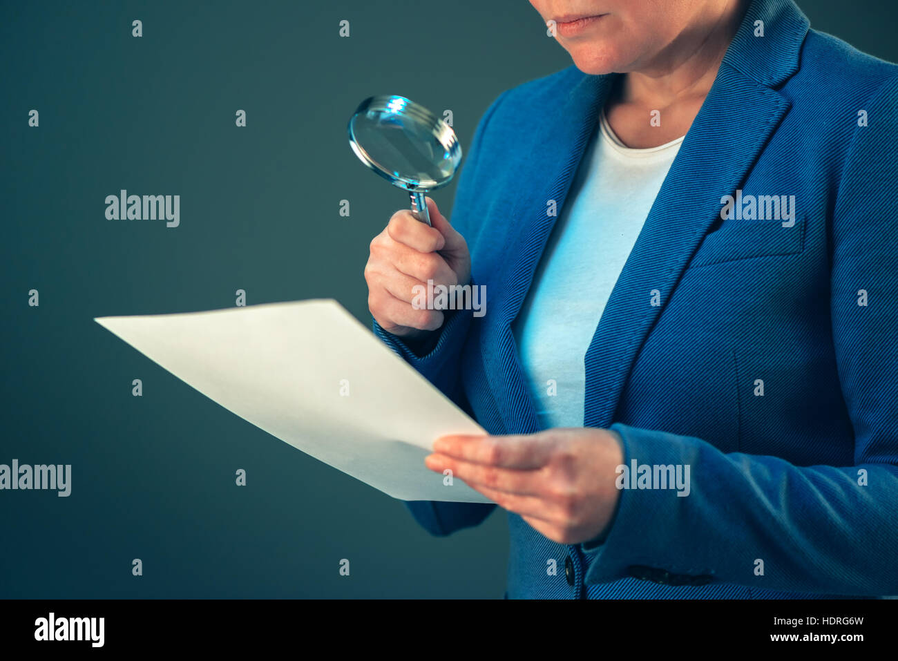 Female tax inspector looking at corporate financial documents with ...