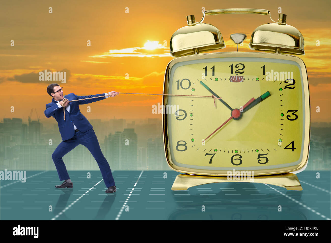 Businessman pulling clock in time management concept Stock Photo - Alamy