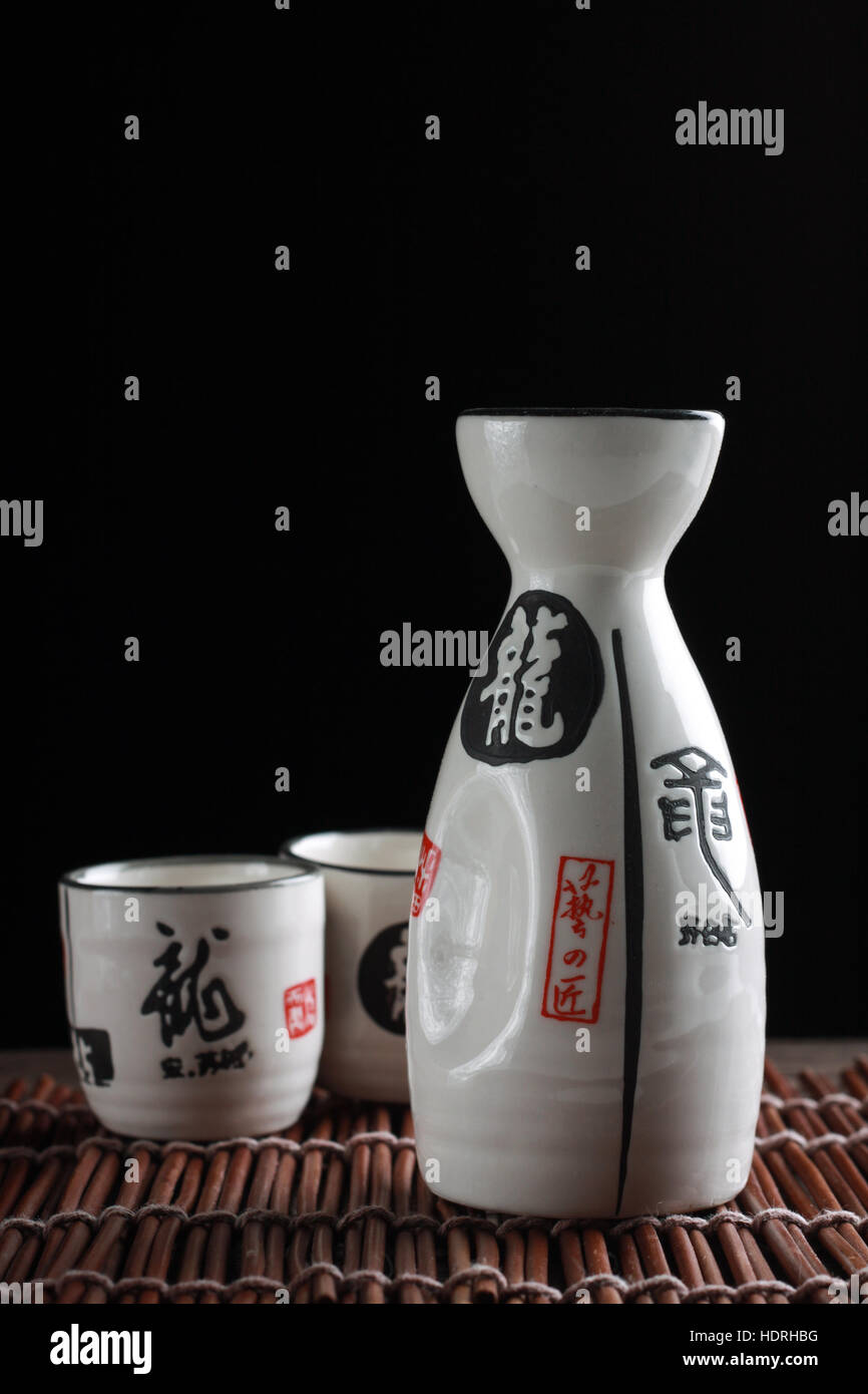 japan sake ceramic botle and cup with black background Stock Photo - Alamy