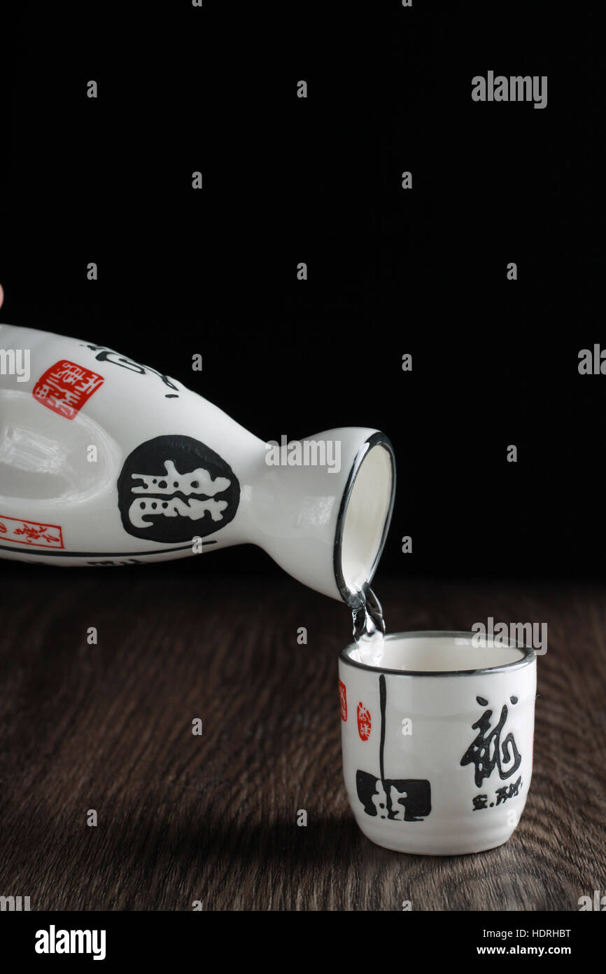 japan sake ceramic botle and cup with black background Stock Photo - Alamy