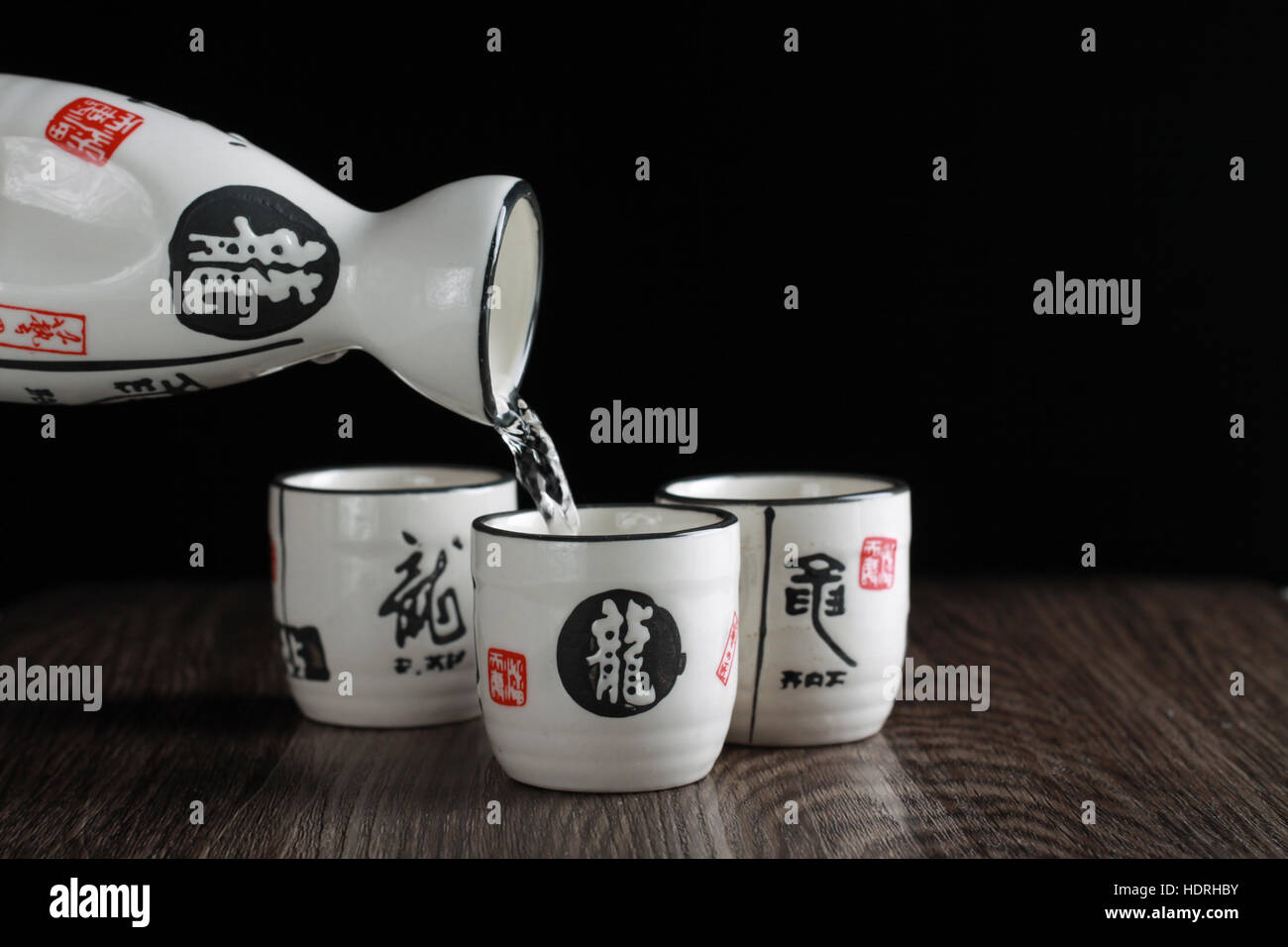 japan sake ceramic botle and cup with black background Stock Photo - Alamy