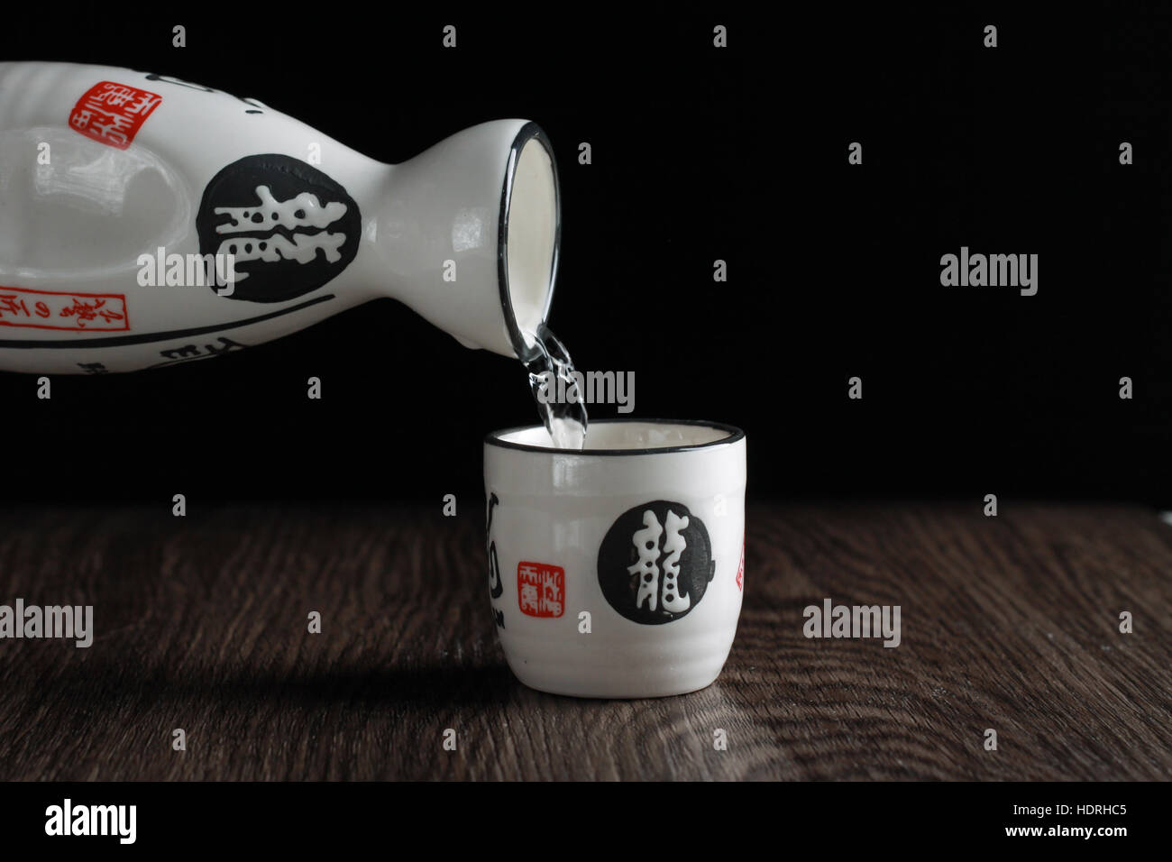 japan sake ceramic botle and cup with black background Stock Photo - Alamy