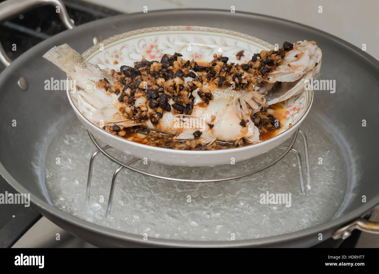 steaming a fresh fish on a pot at home Stock Photo - Alamy