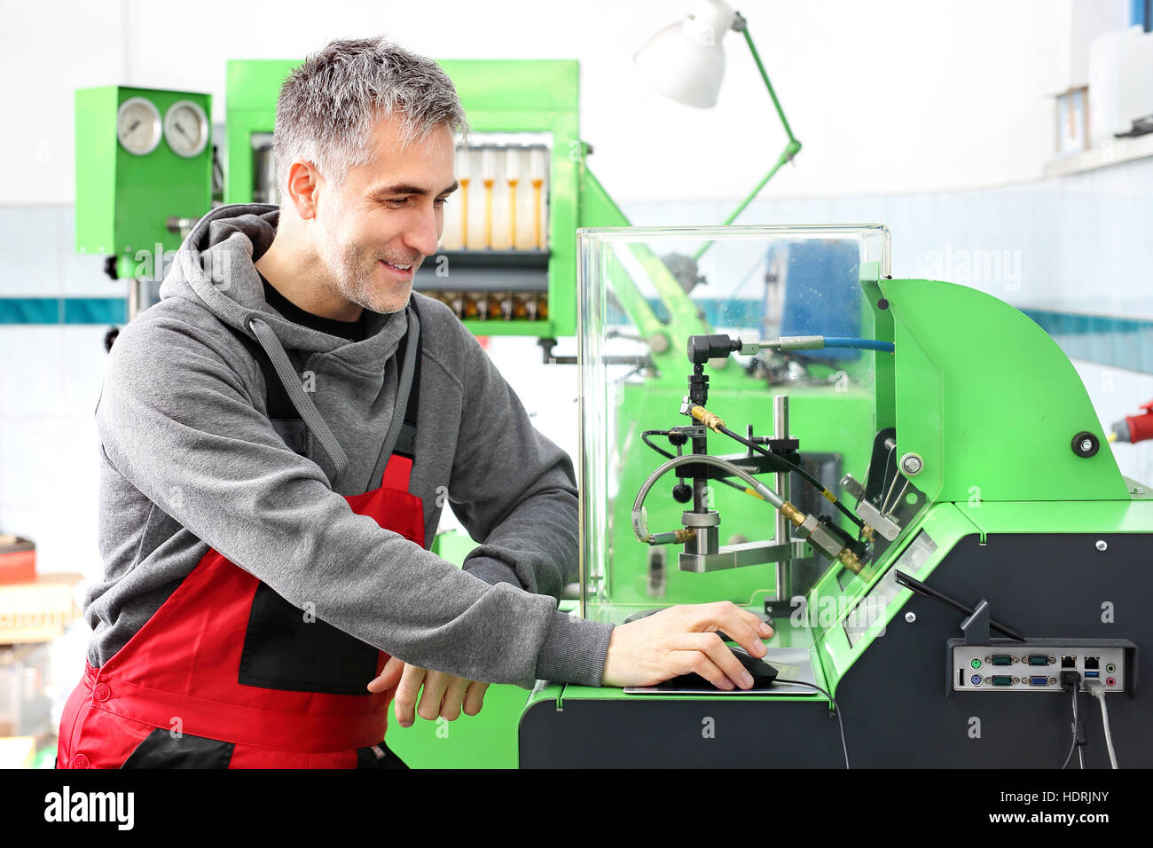 Injector tester. Car mechanic in the workshop. Auto mechanic workshop ...