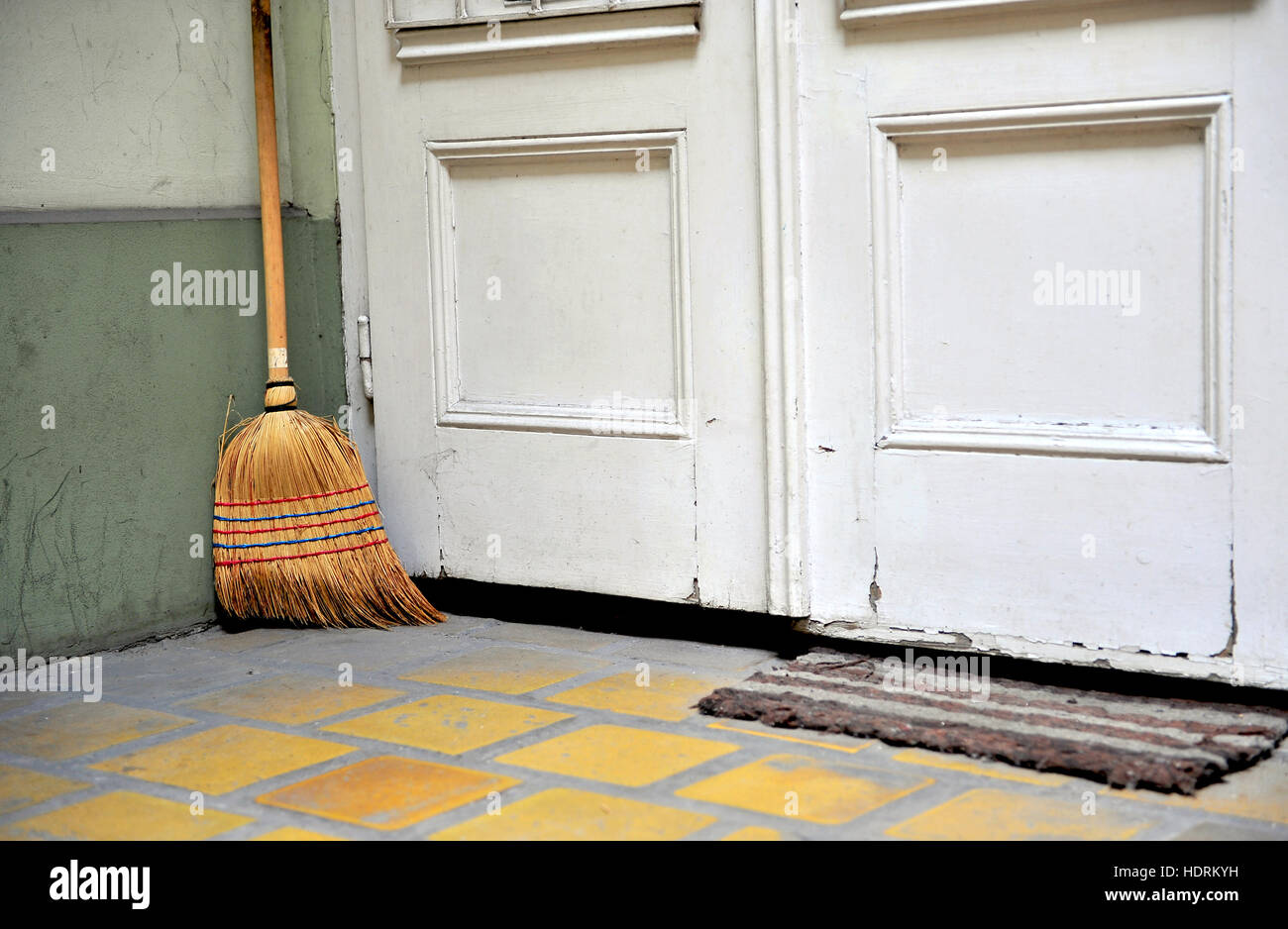Broom at the white wooden door Stock Photo - Alamy