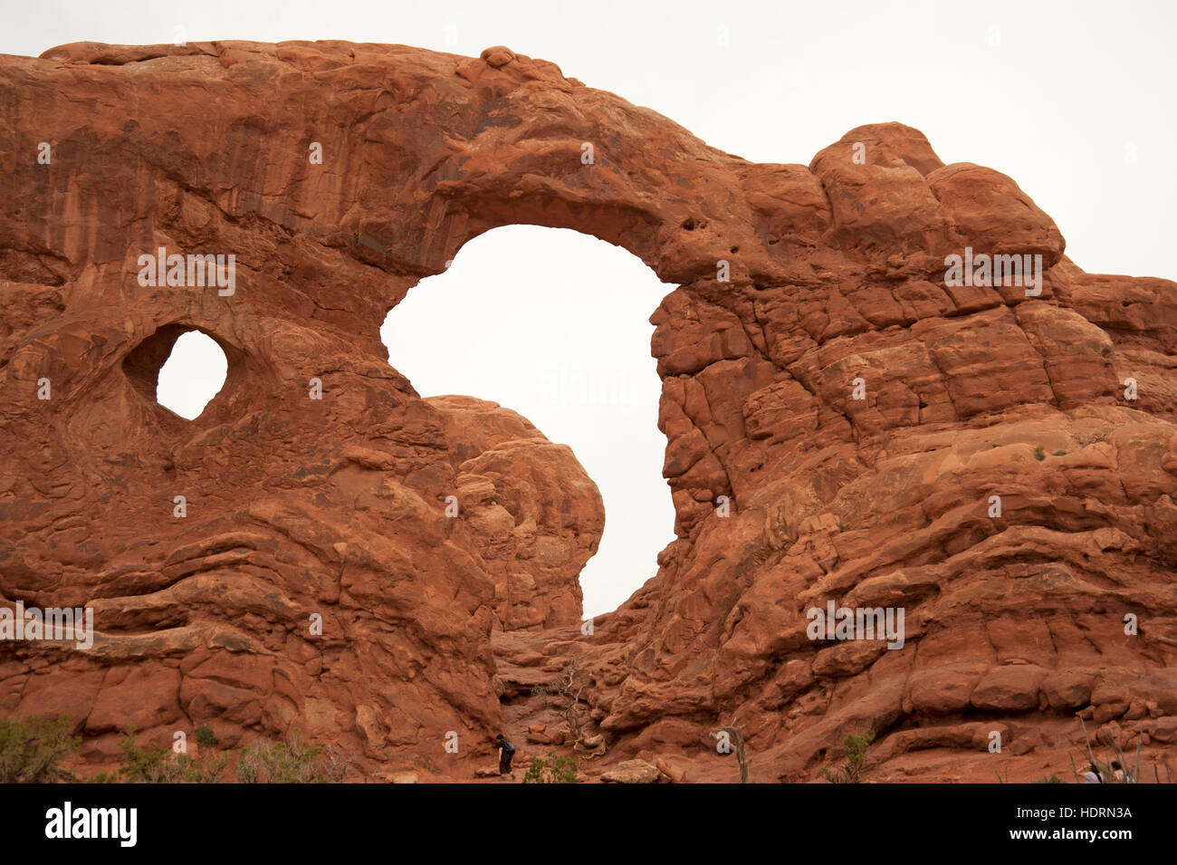 Double red sandstone arch of unusual formed by erosion of wind and rain ...