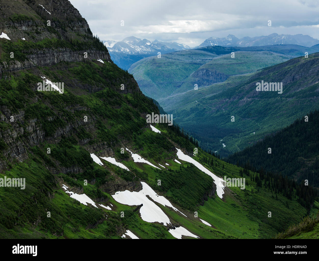 Extreme terrain in mountain range under cloudy sky, Glacier National ...