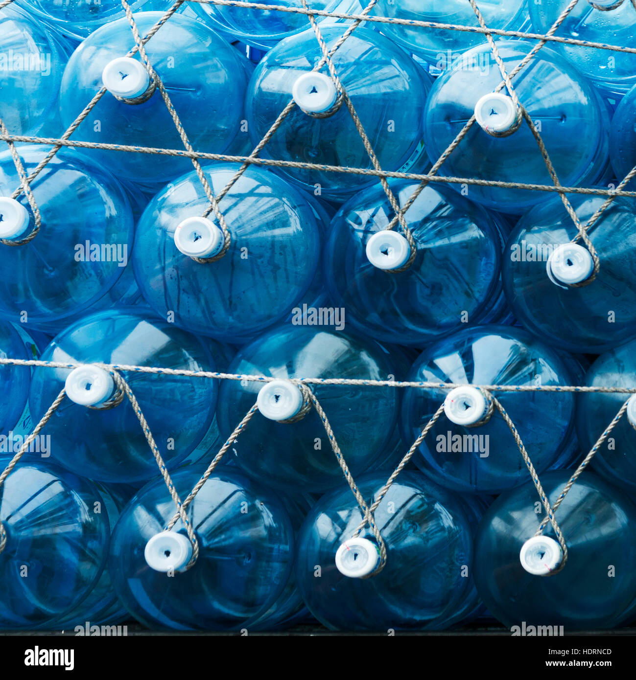 Blue plastic water containers with white lids attached by rope; Seoul ...