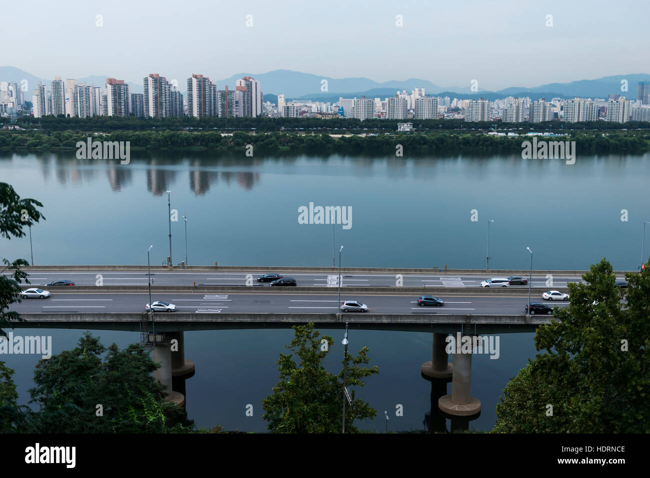 Buildings with a mountain range in the distance and a road going over ...