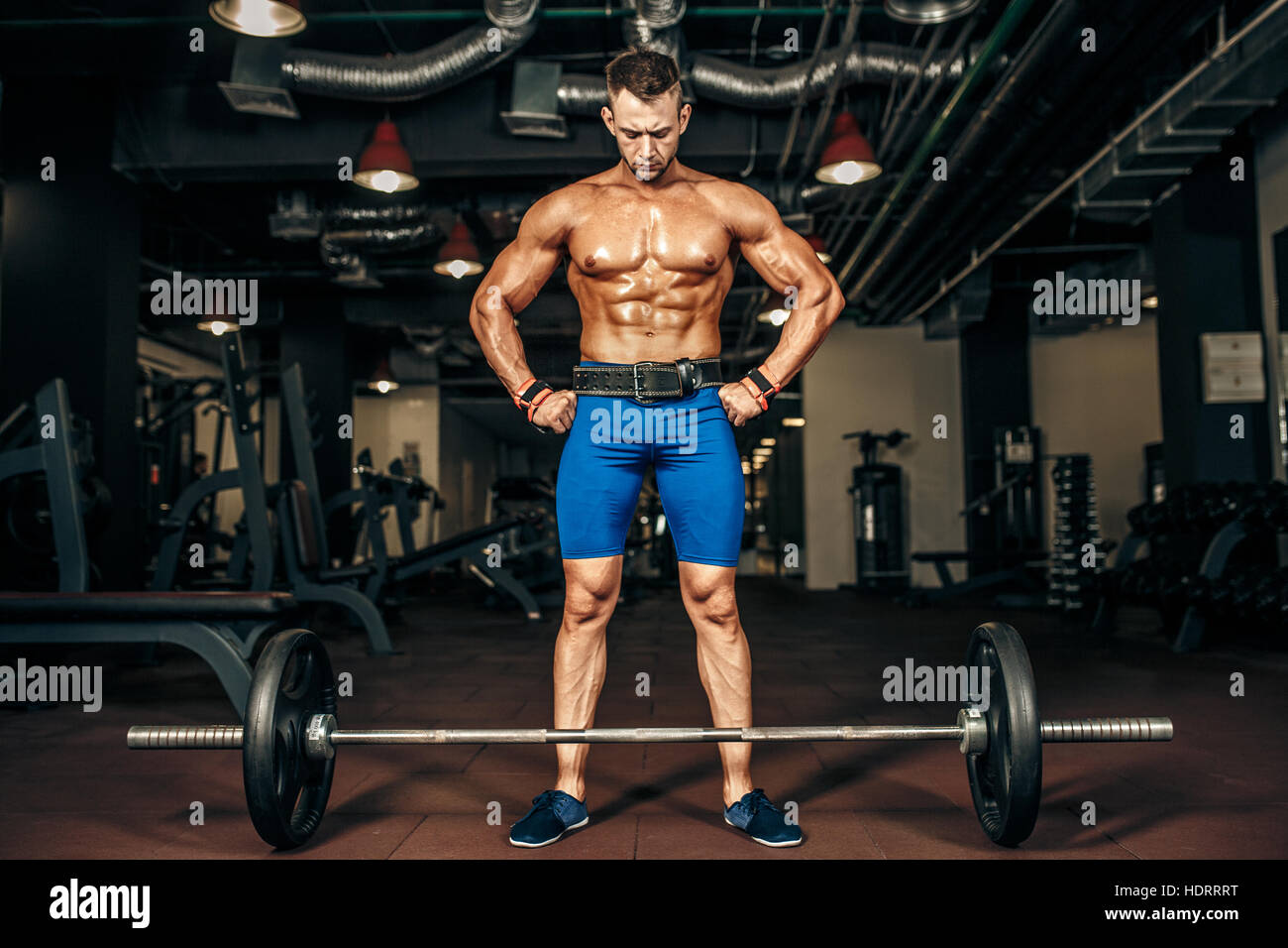 Strong Bodybuilder preparing for deadlift of barbell in the gym Stock ...