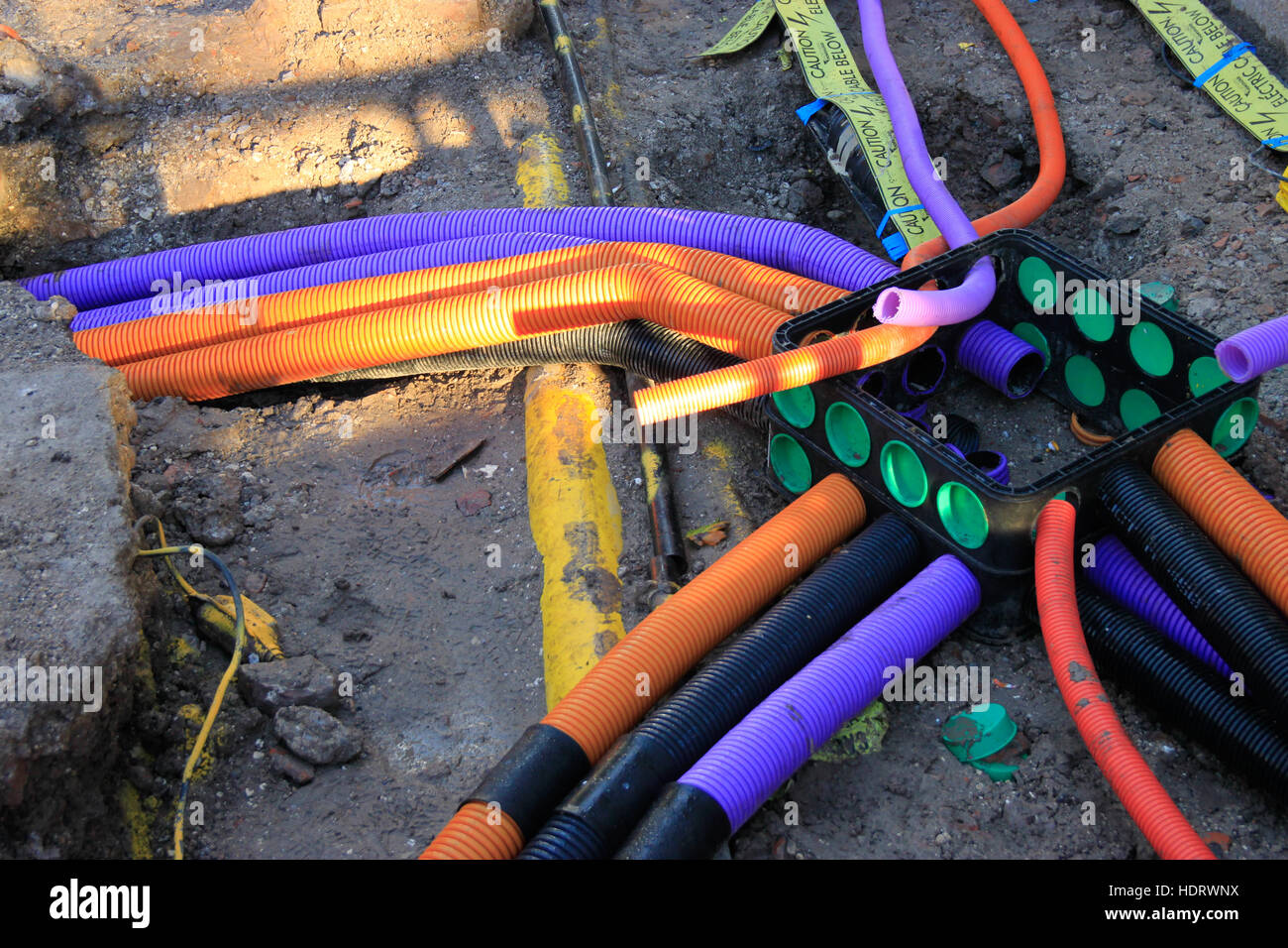 Multicoloured pipes for wiring underground Stock Photo - Alamy
