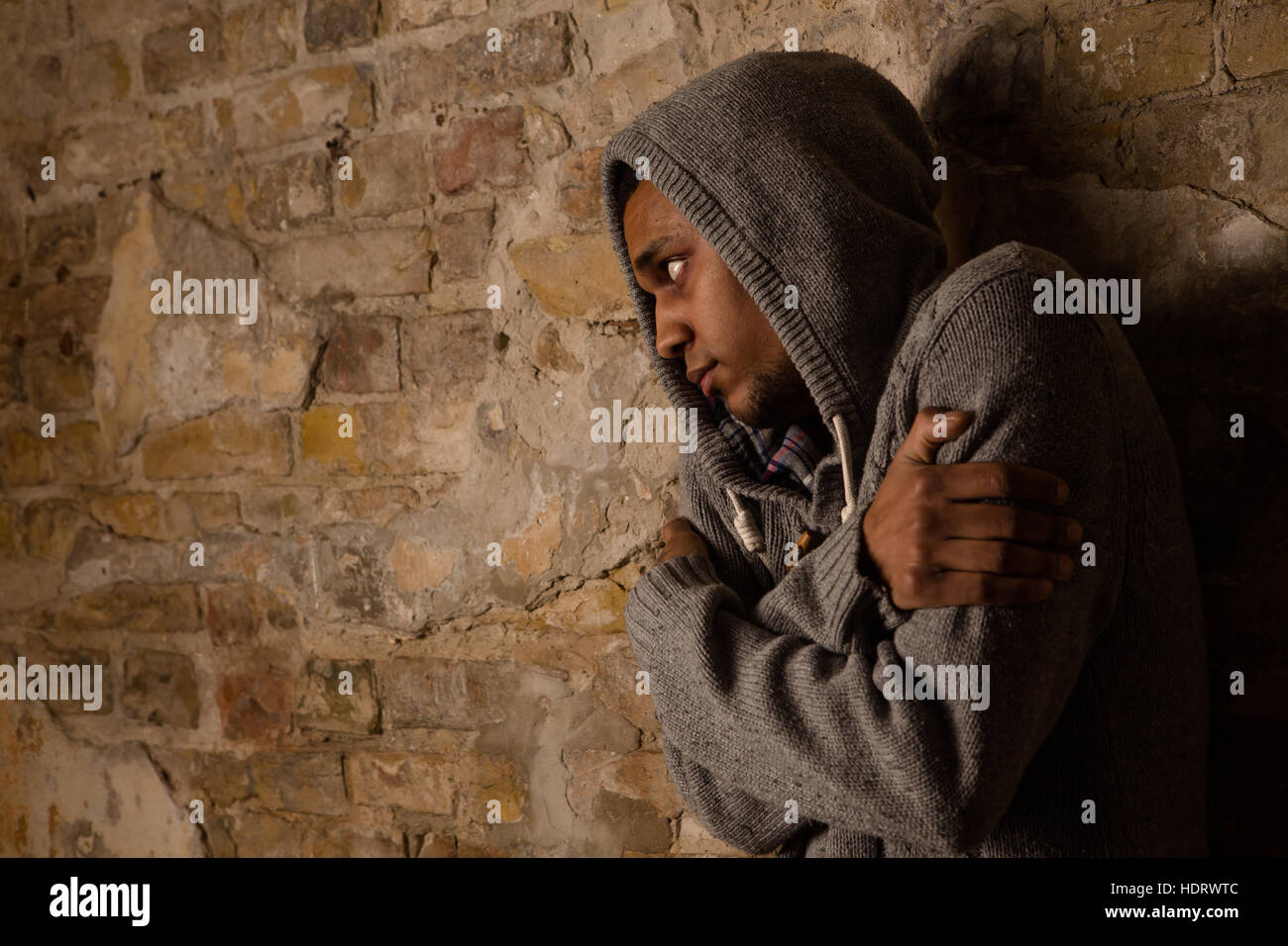 Drug addict posing near brick wall Stock Photo - Alamy