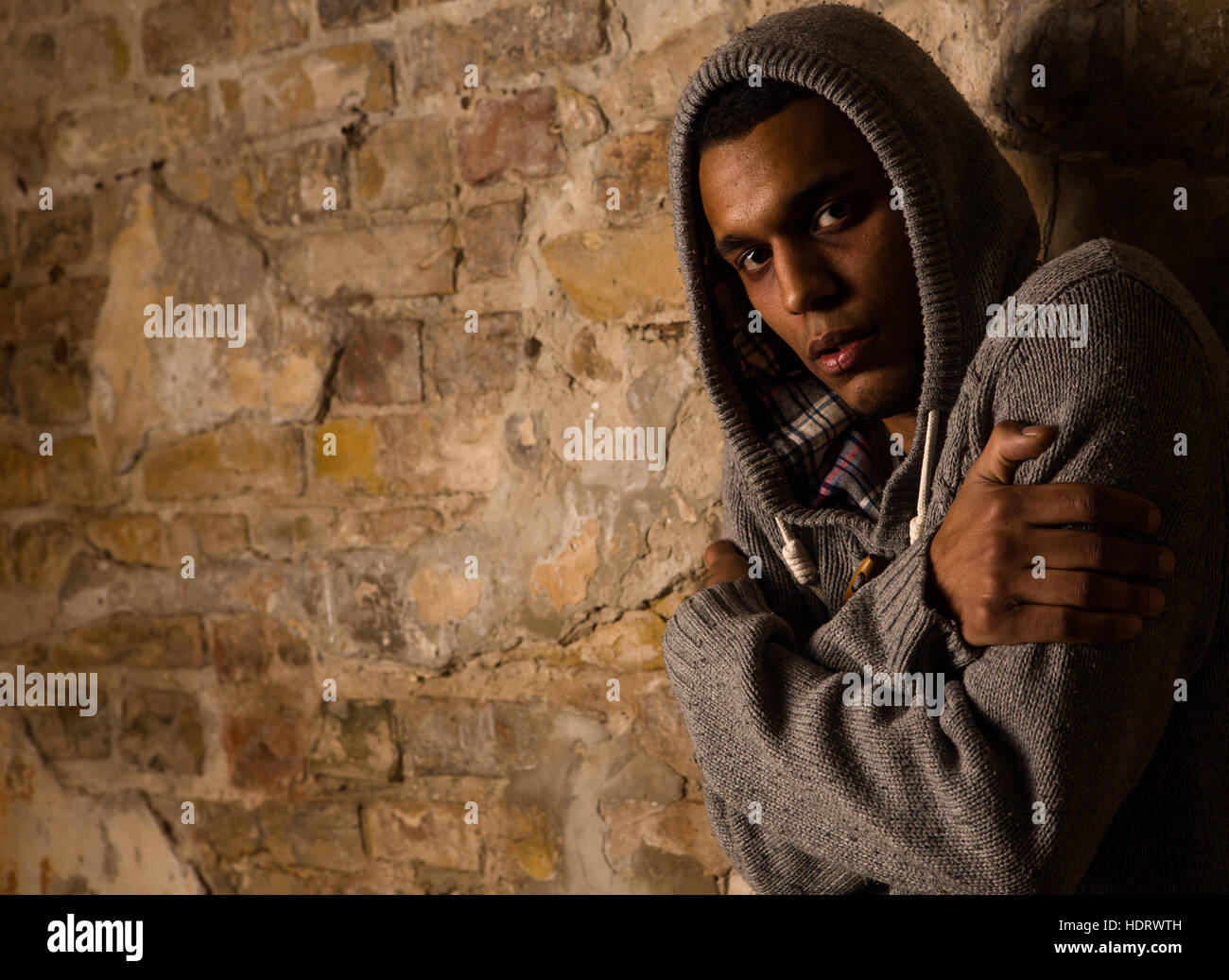 Drug addict posing near brick wall Stock Photo - Alamy