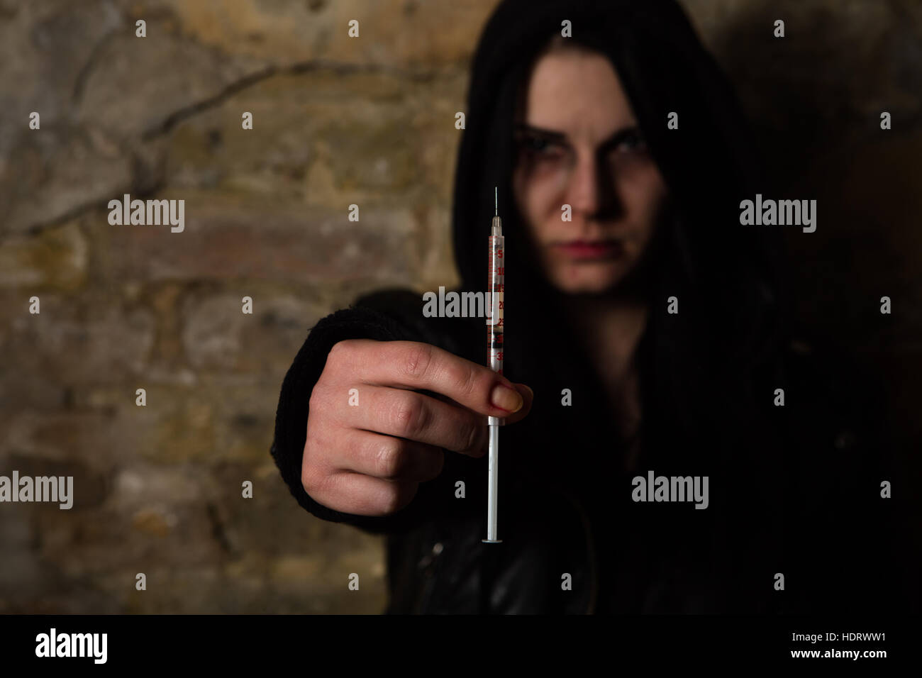 Drug addict posing near brick wall Stock Photo - Alamy