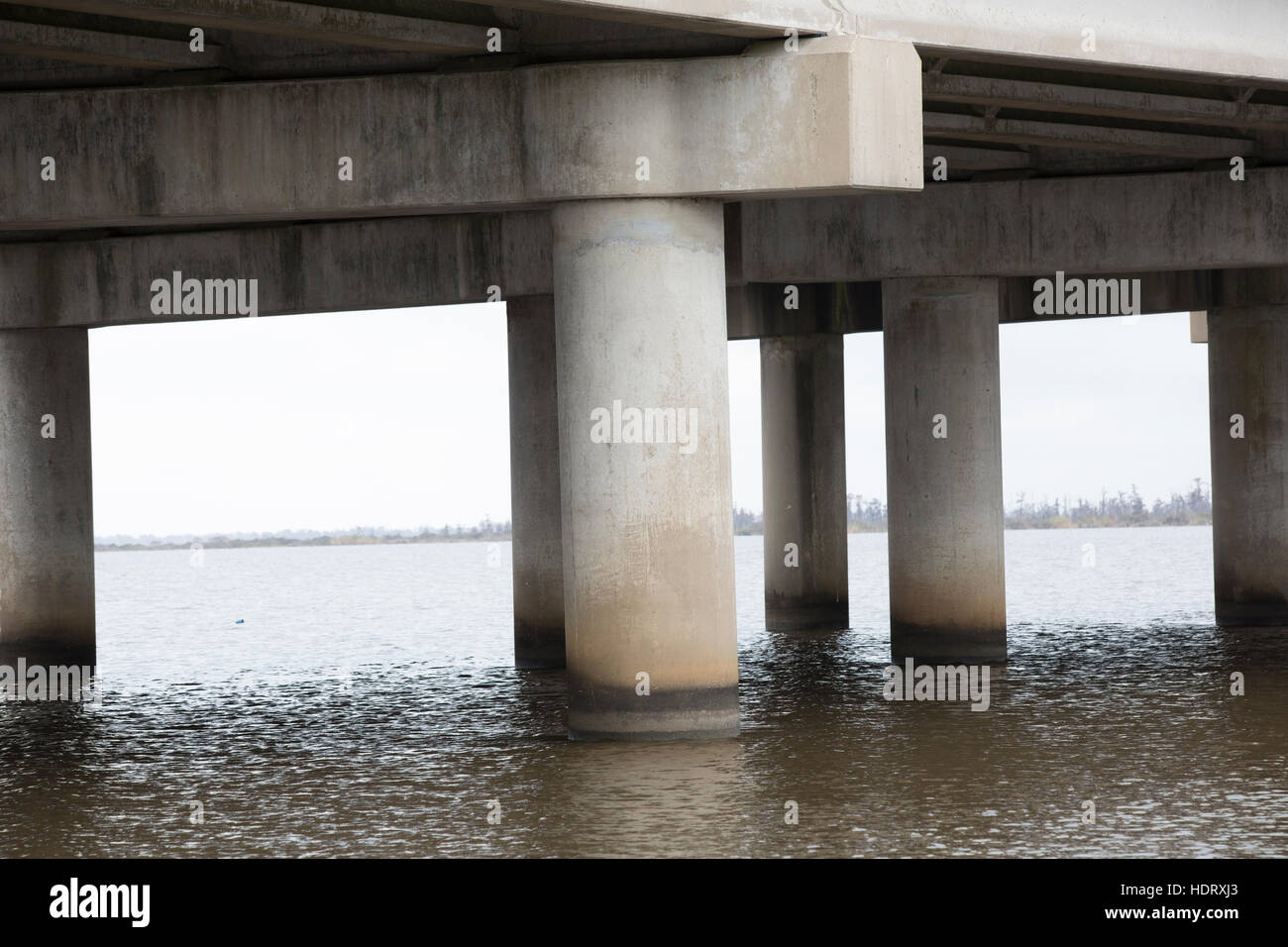 Pillars of overpass over water Stock Photo - Alamy