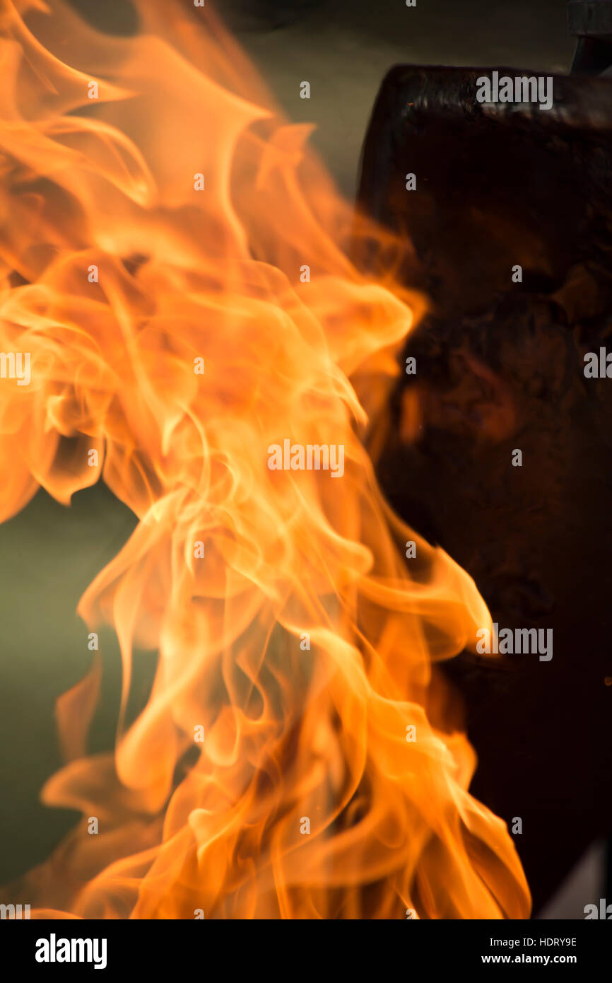 Close-up of flames shooting from grill Stock Photo - Alamy