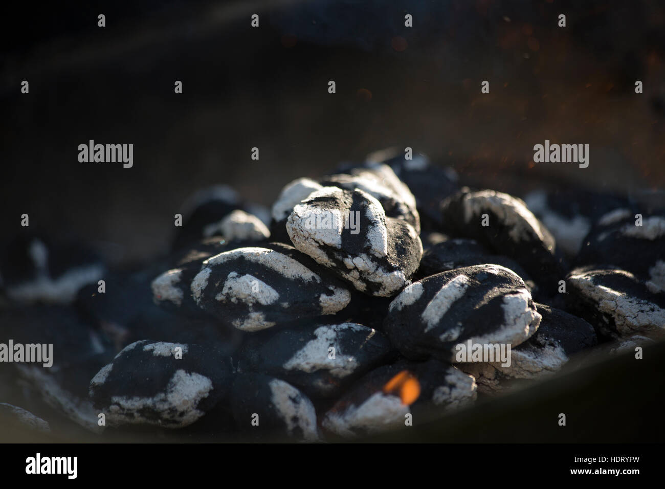 Smoking charcoal with small flame Stock Photo - Alamy