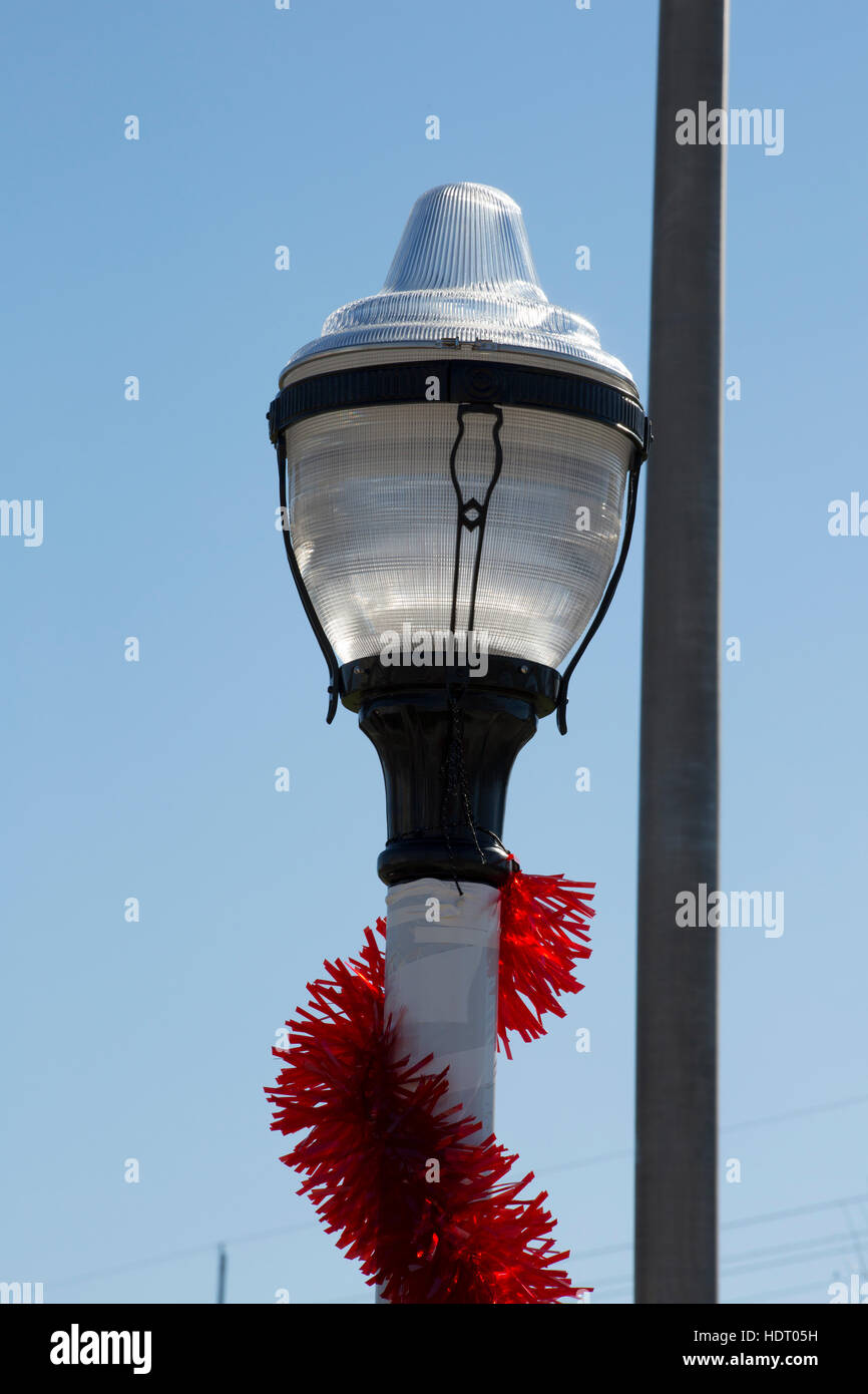 Christmas garland wrapped around lamp pole Stock Photo - Alamy