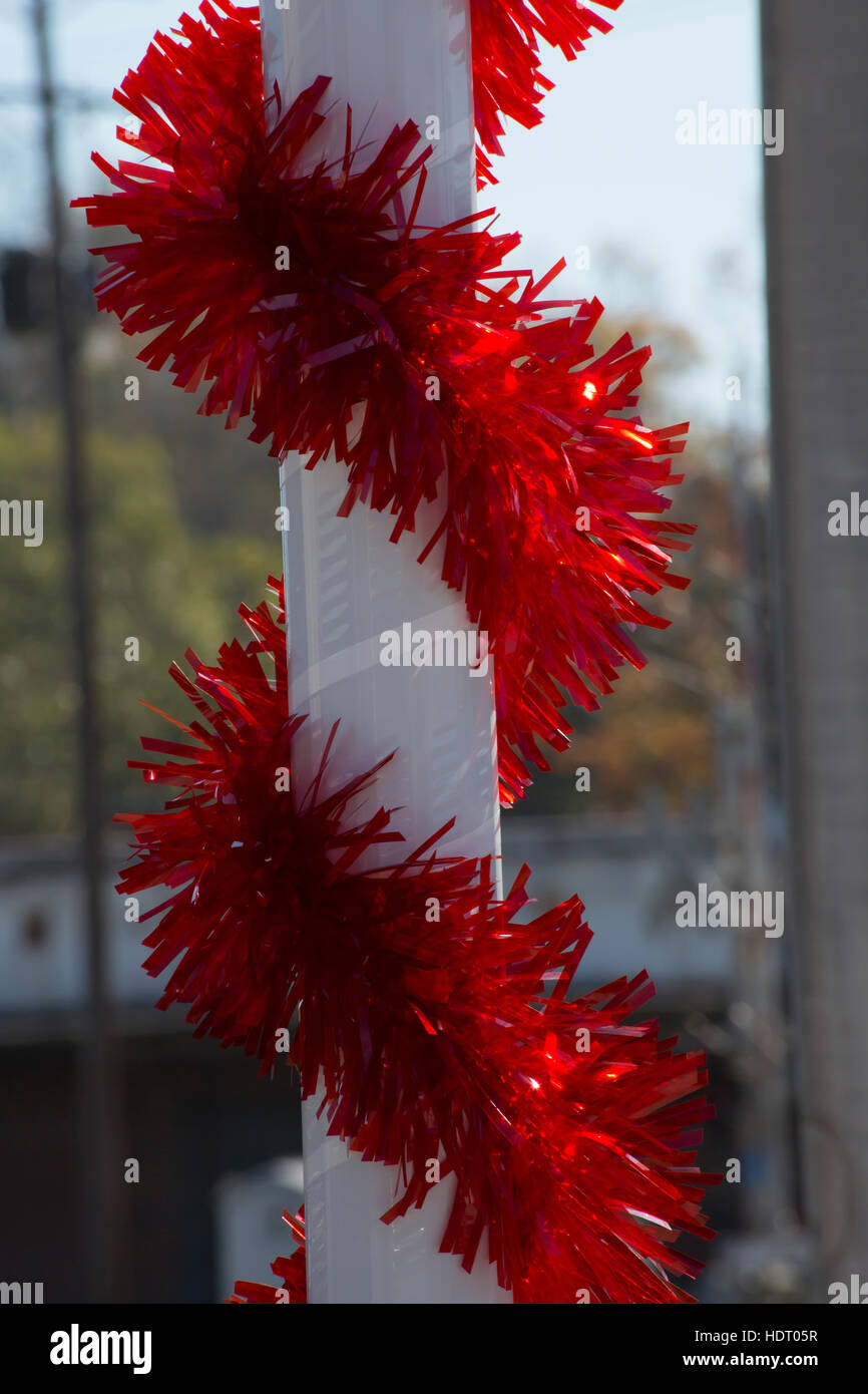 Red Christmas garland wrapped around pole Stock Photo - Alamy