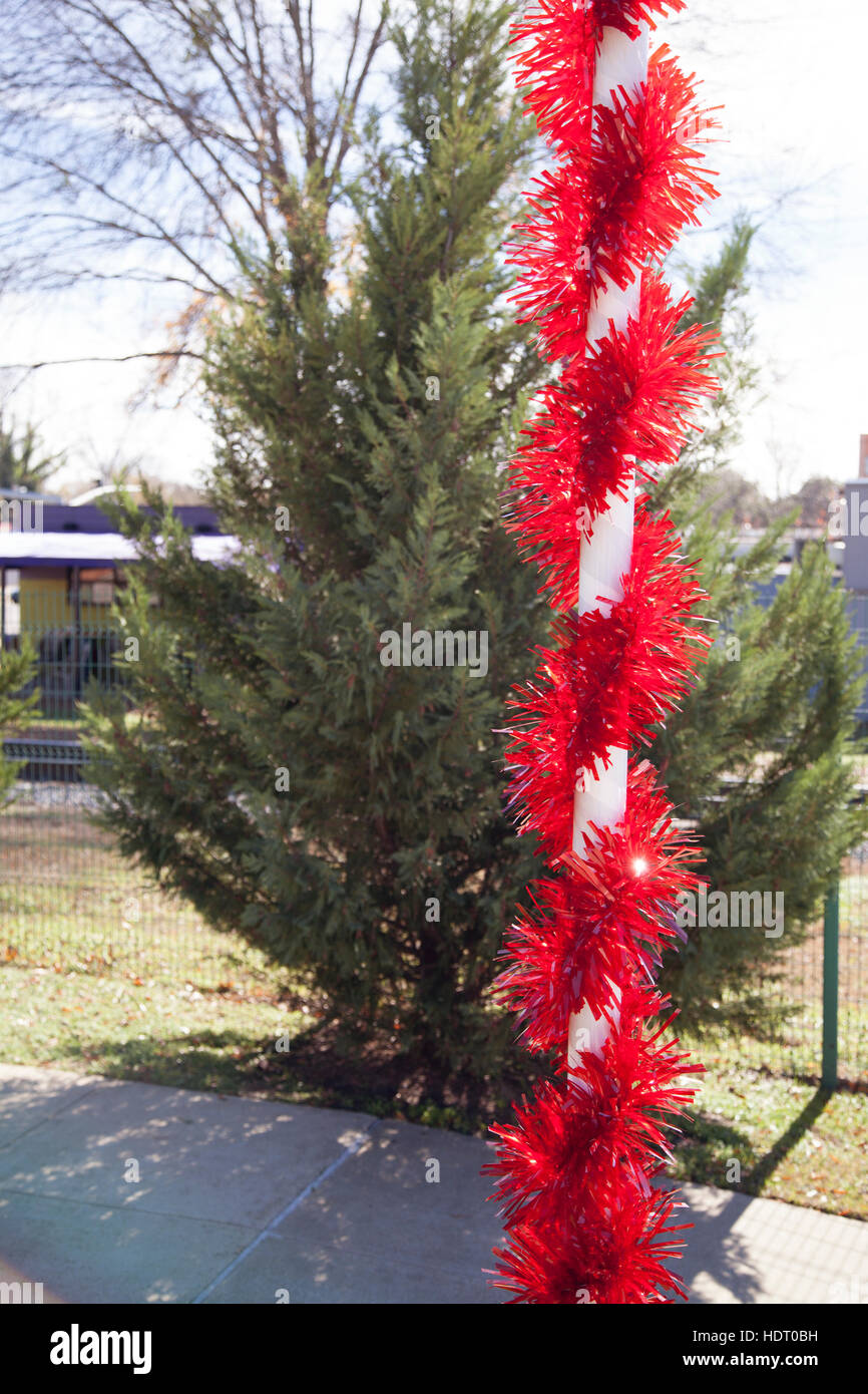 Red Christmas garland wrapped around pole Stock Photo - Alamy