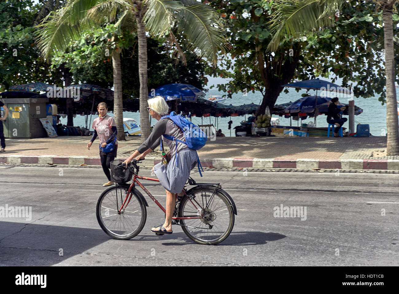 Female cycling alone. Mature woman cycling alone along the street Stock ...