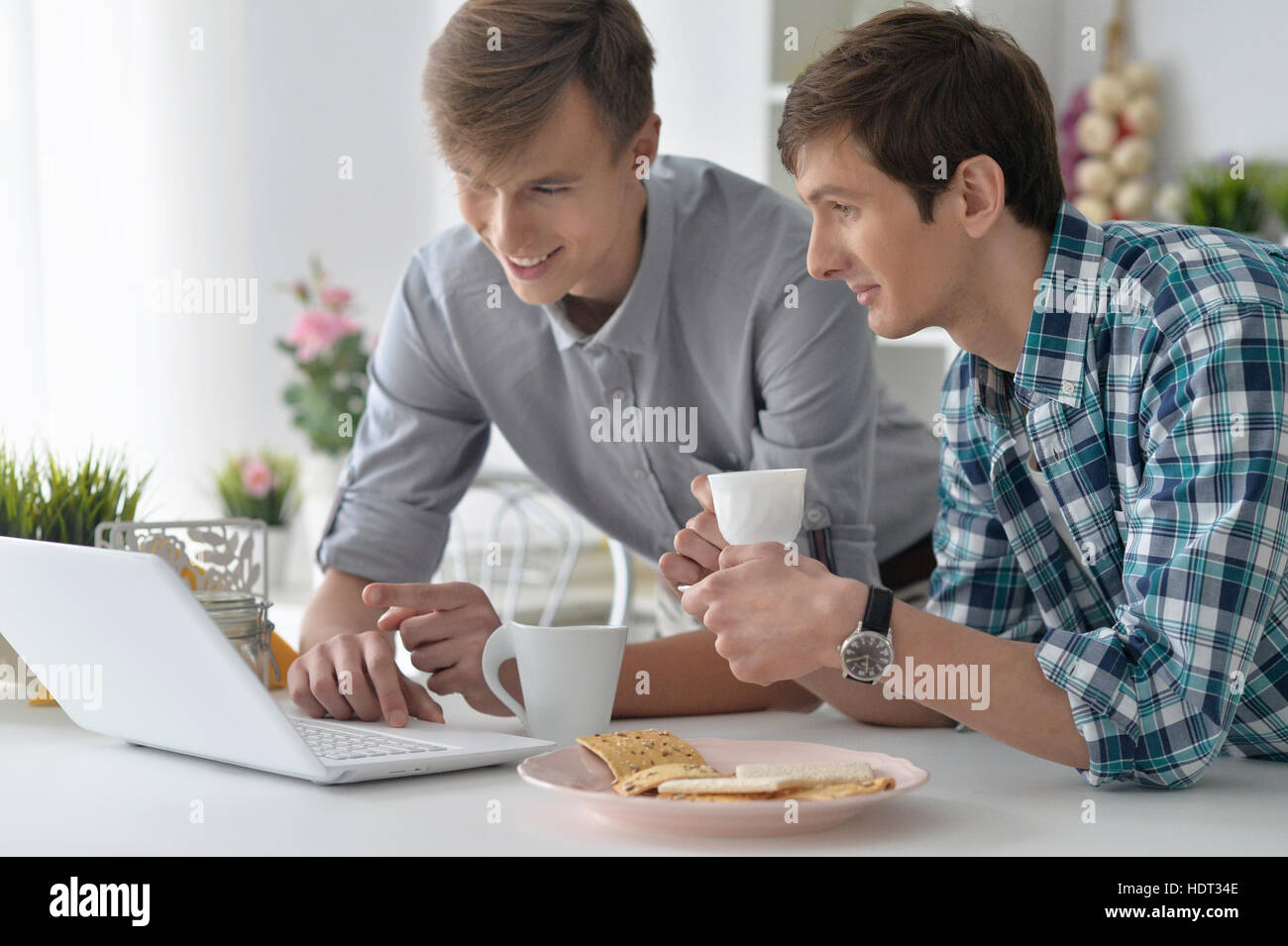 men watching video on laptop Stock Photo - Alamy