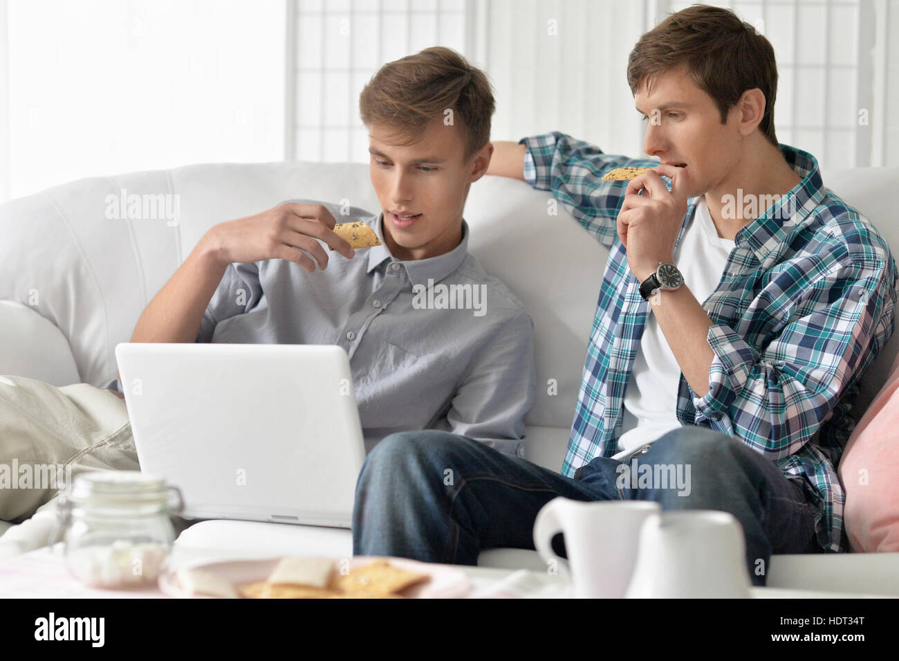 men watching video on laptop Stock Photo - Alamy