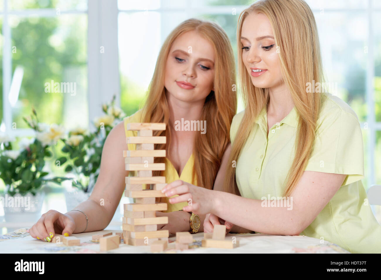 girls playing table game Stock Photo - Alamy