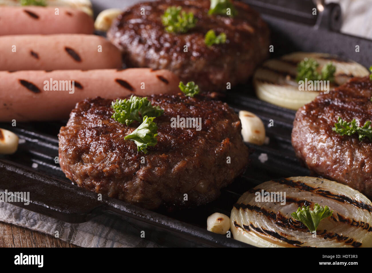 grilled burgers with vegetables in a pan grill closeup. horizontal ...