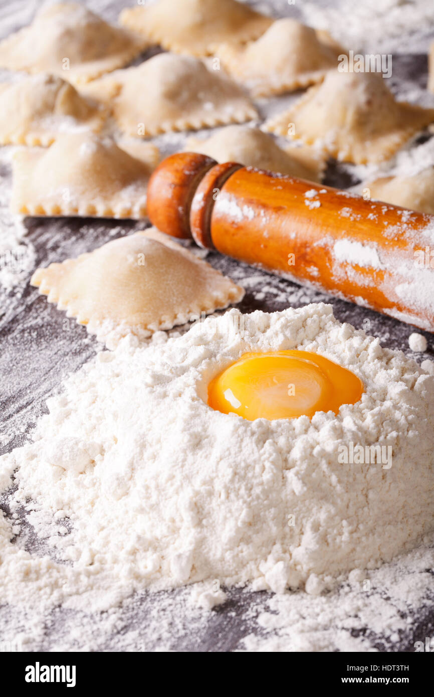 Italian ravioli with raw ingredients on the table close-up. Vertical ...