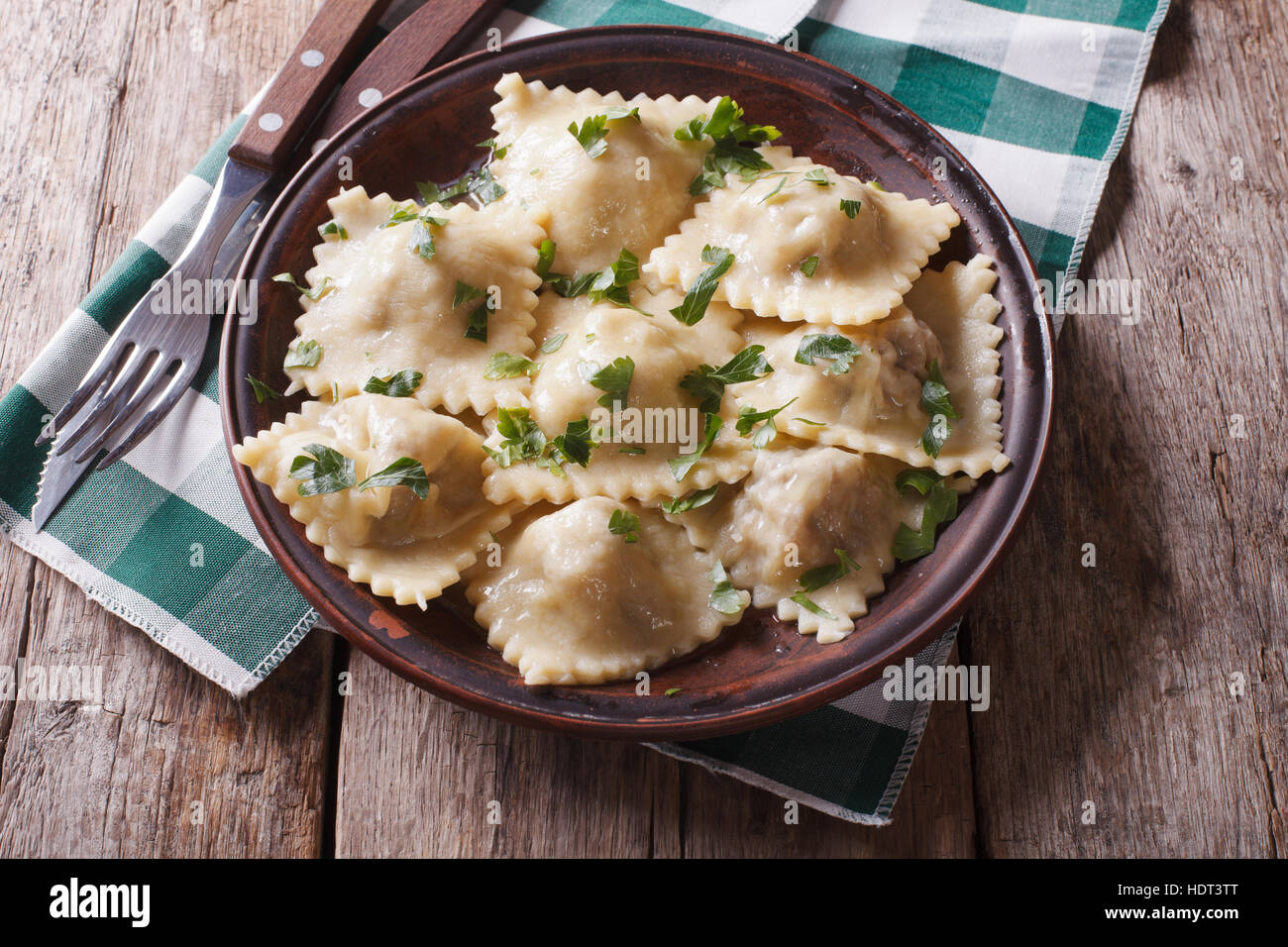 Italian ravioli on a plate with herbs. horizontal view from above ...