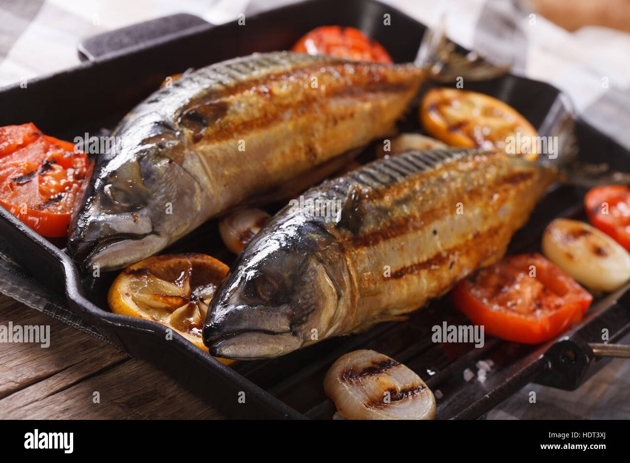 delicious grilled sea fish and vegetables in a pan grill closeup ...