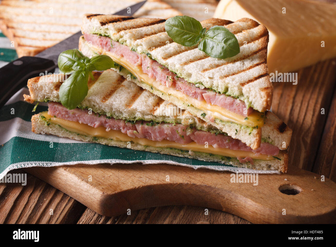 Grilled triangular toast with ham closeup on a chopping board ...