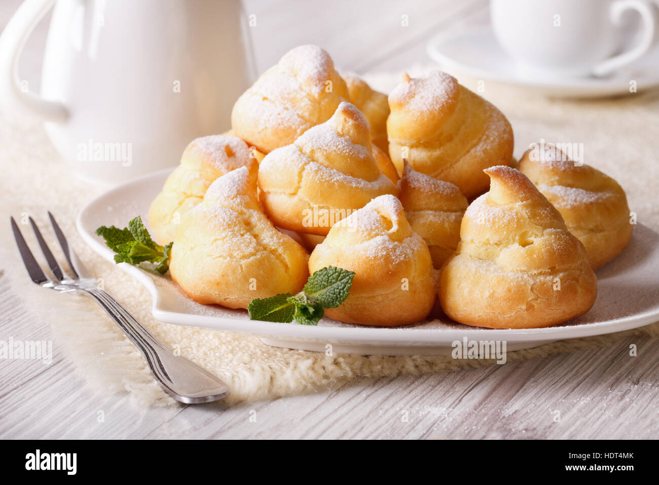profiteroles topped with powdered sugar on a plate. horizontal Stock ...
