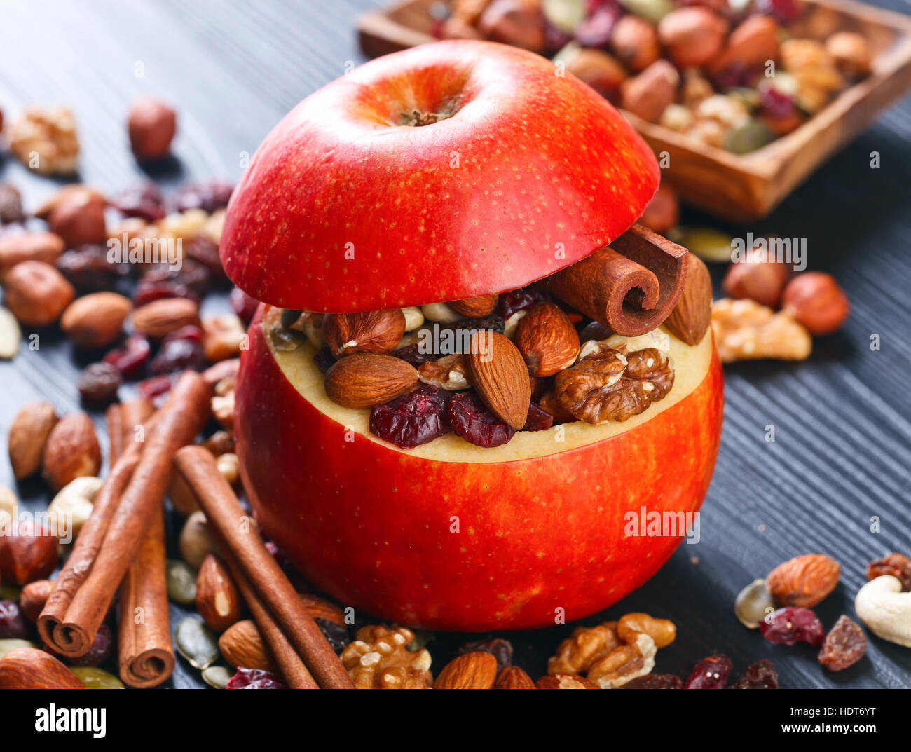 Red juicy apple with assorted nuts , raisins and cinnamon sticks Stock ...