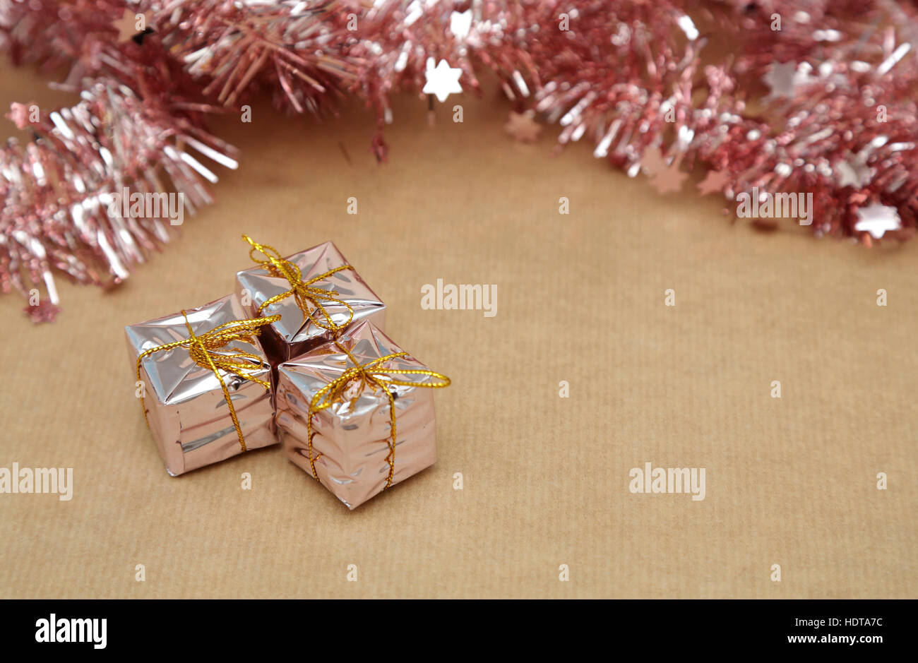 Christmas background with decorations, pink tinsel and gift boxes on ...