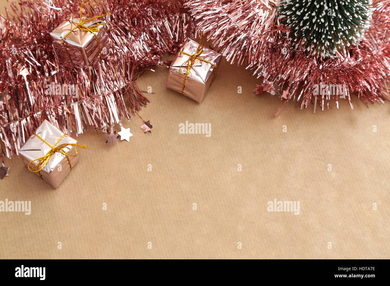 Christmas background with decorations, pink tinsel and gift boxes on ...
