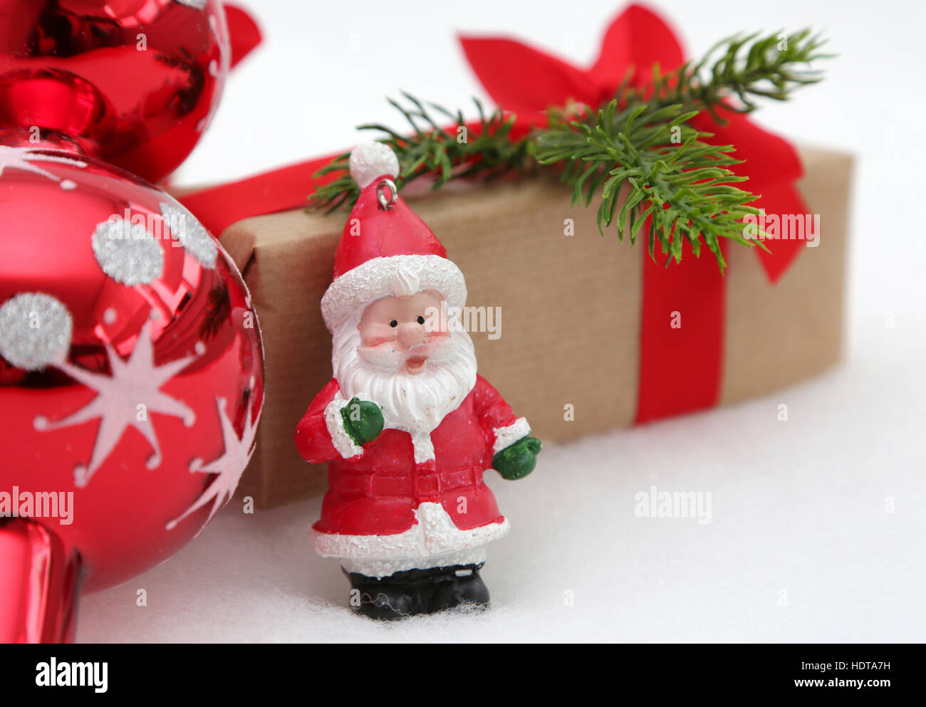 Santa Claus in front of a Christmas present Stock Photo - Alamy