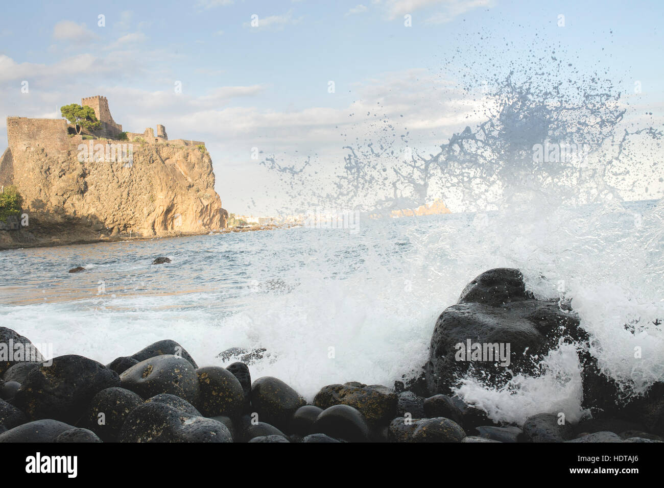 Deep blue sea waves splashing volcanic rocks, Aci Castello in ...