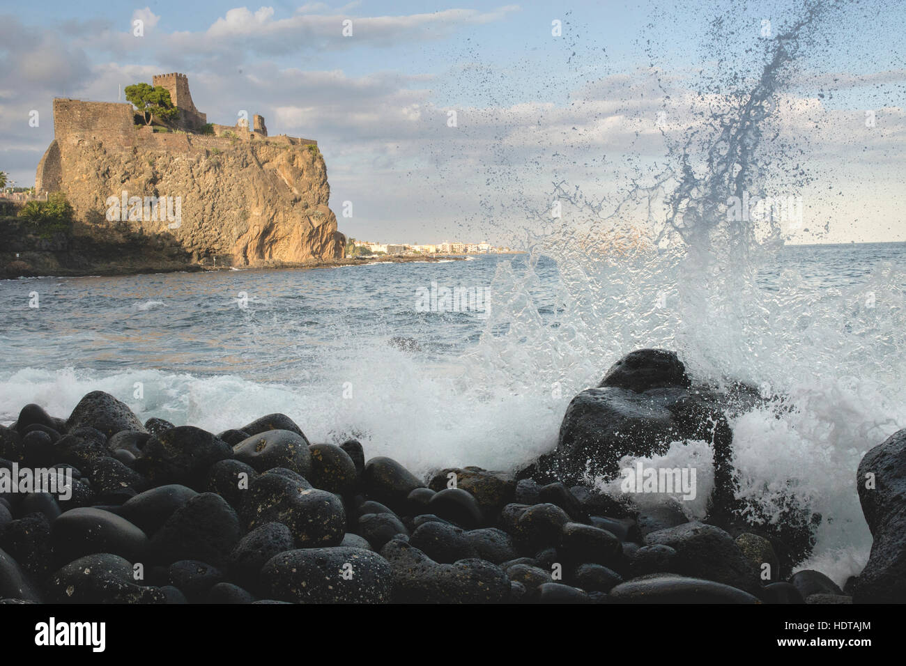 Deep blue sea waves splashing volcanic rocks, Aci Castello in ...