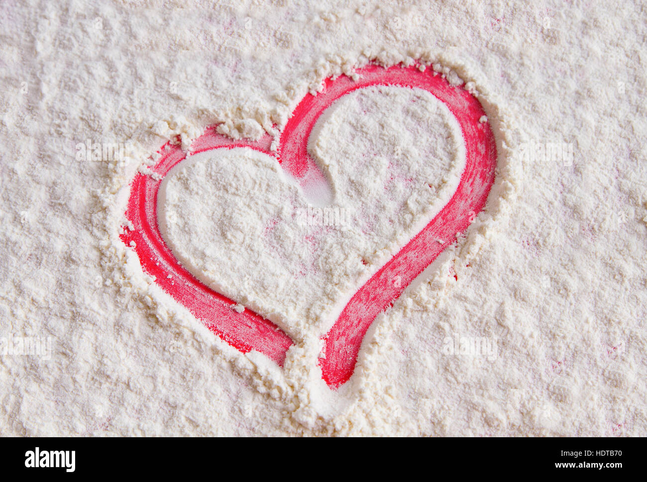 Red heart on flour background, top view Stock Photo - Alamy