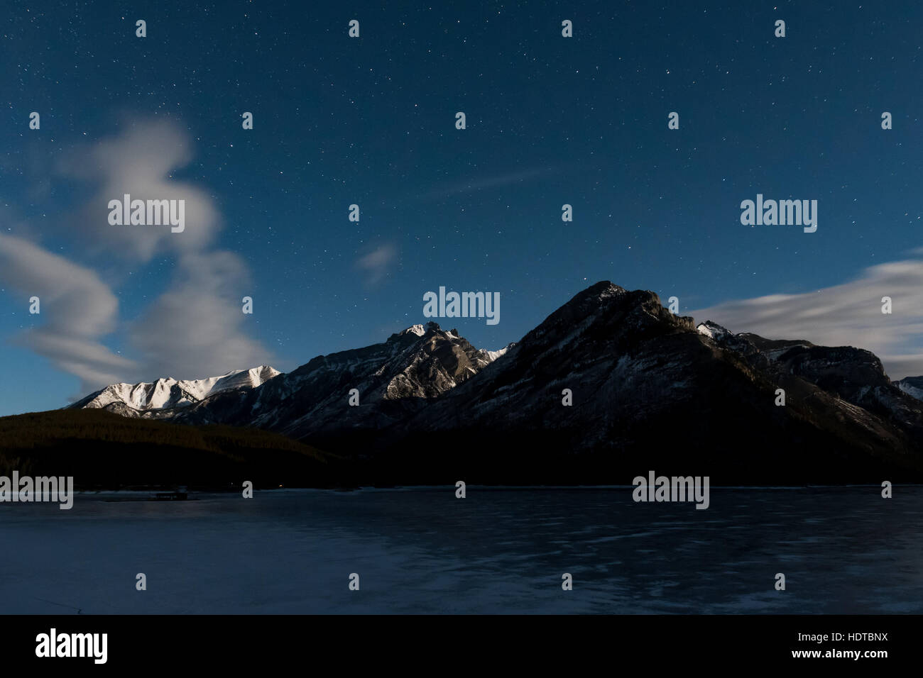Starry night scene in the mountains lake Minnewanka, Banff National ...