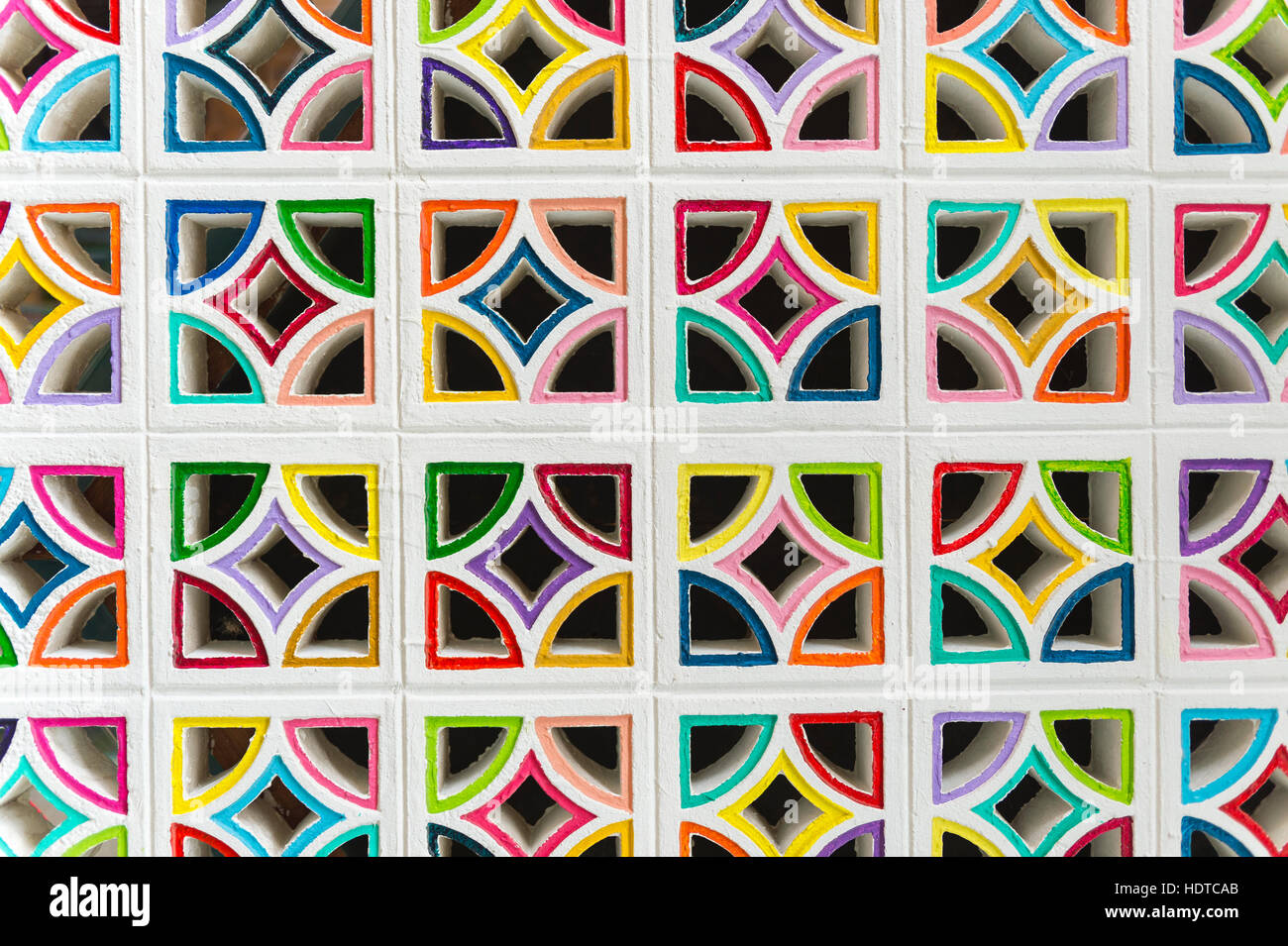 Abstract close-up of wall of concrete blocks with brightly painted ...